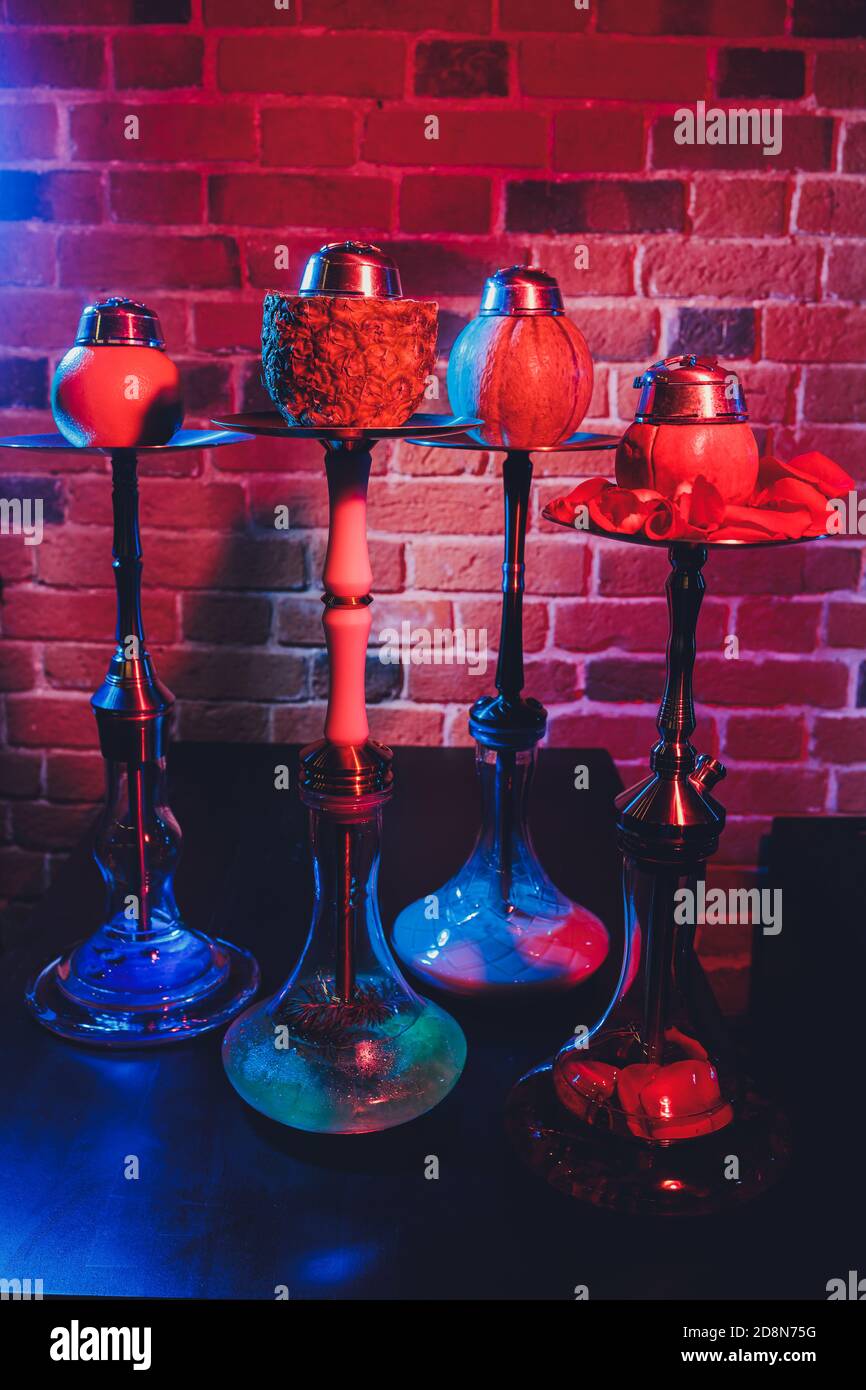 Red shisha hookah with smoke and red sparks on wood table brick, art ...
