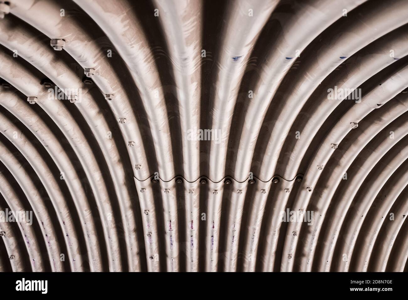 Inside of a large tube with symmetrical folds, made of metallic ...
