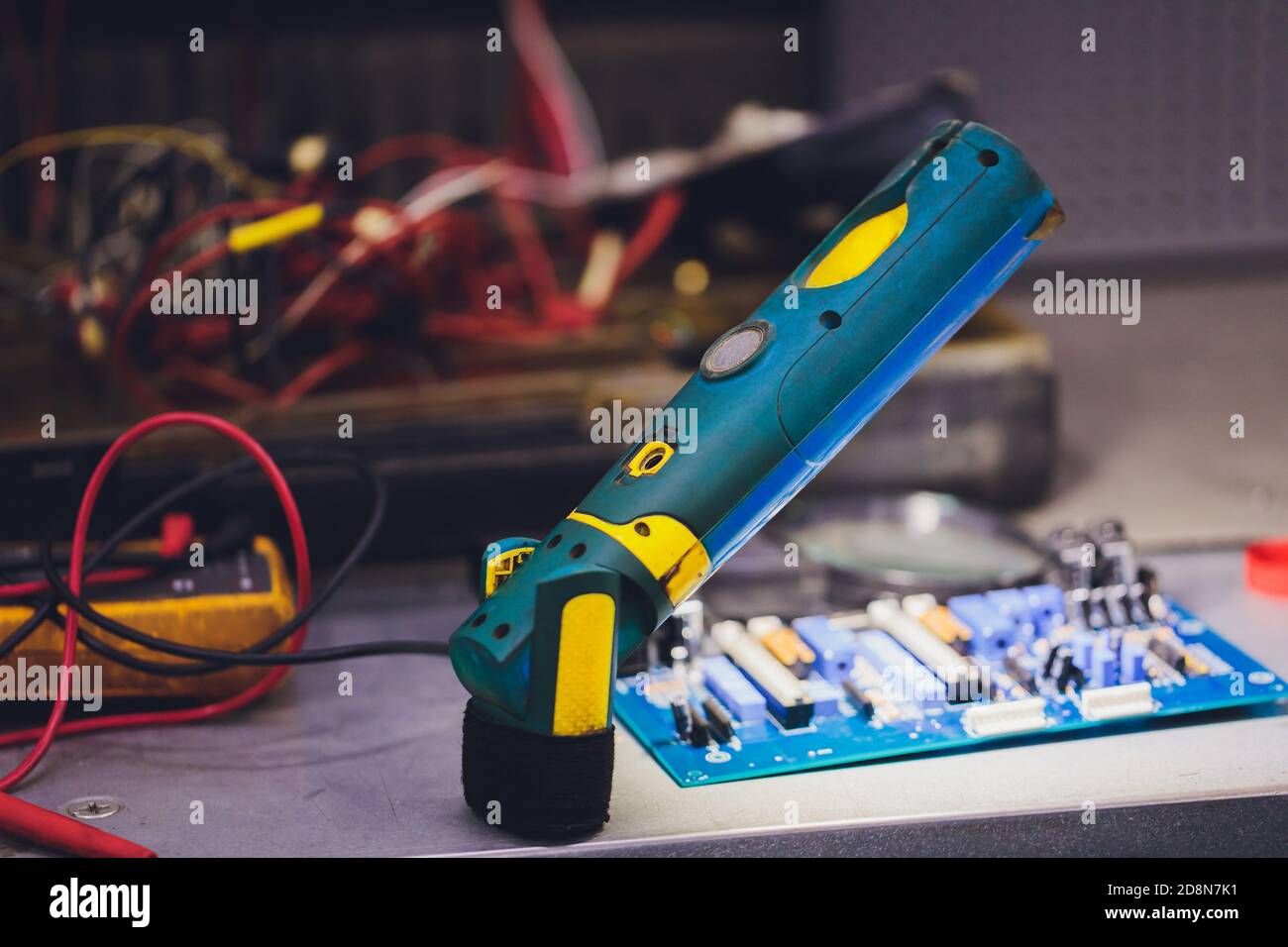 Closeup on electronic board in hardware repair shop, blurred and toned ...