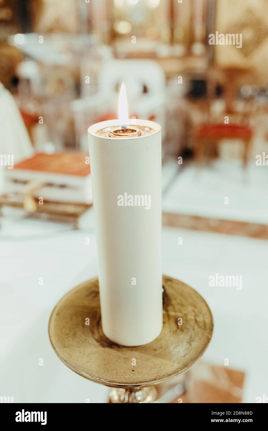 A large religious candle lit inside a church Stock Photo - Alamy