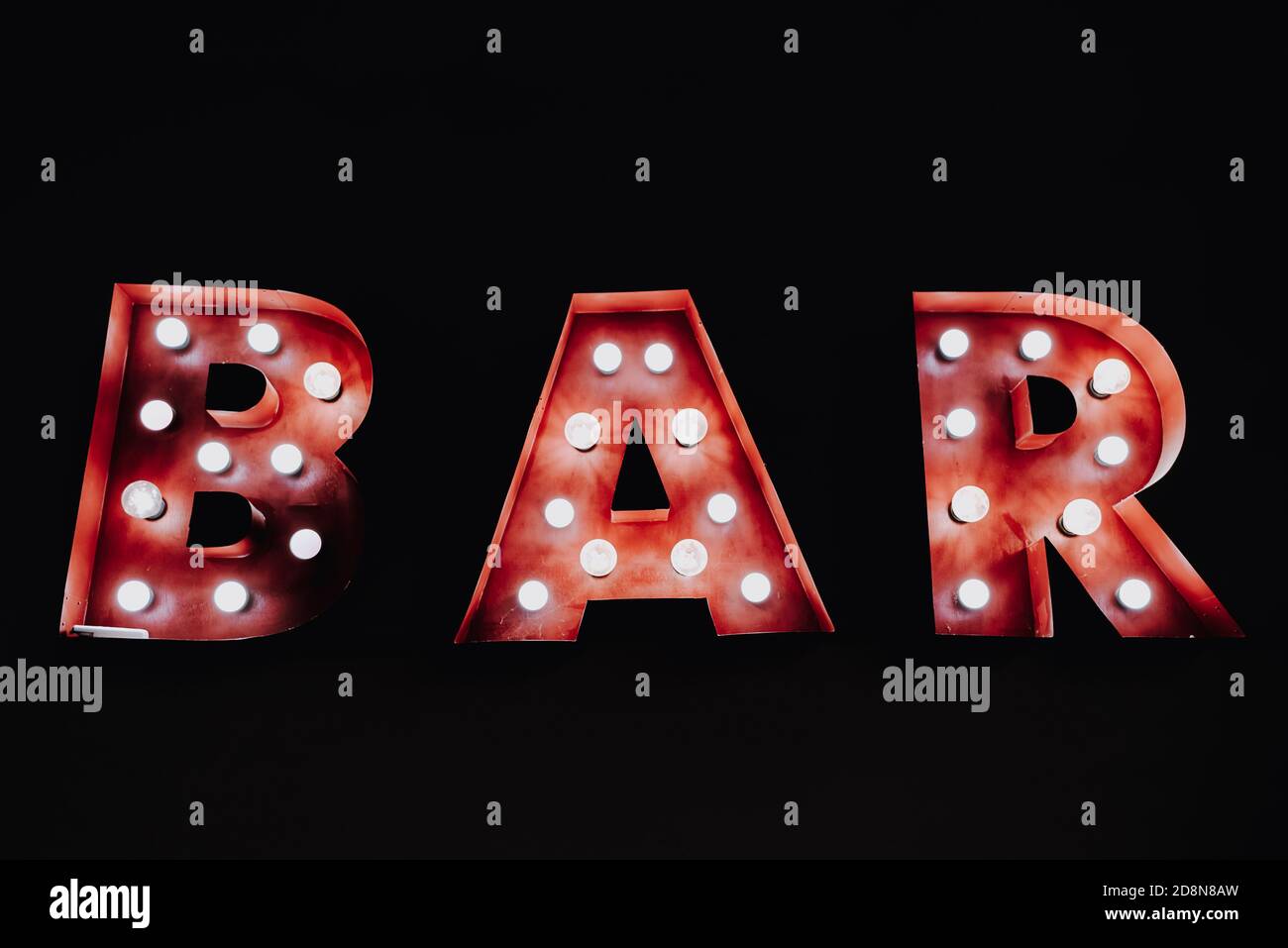 Bar written with luminous bulbs on a dark black background Stock Photo ...