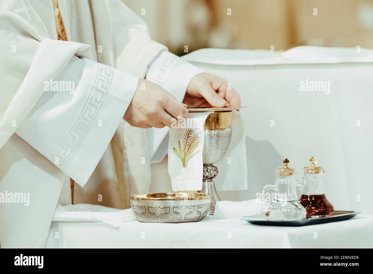 Christian priest prepares the supplies for the consecration liturgy ...