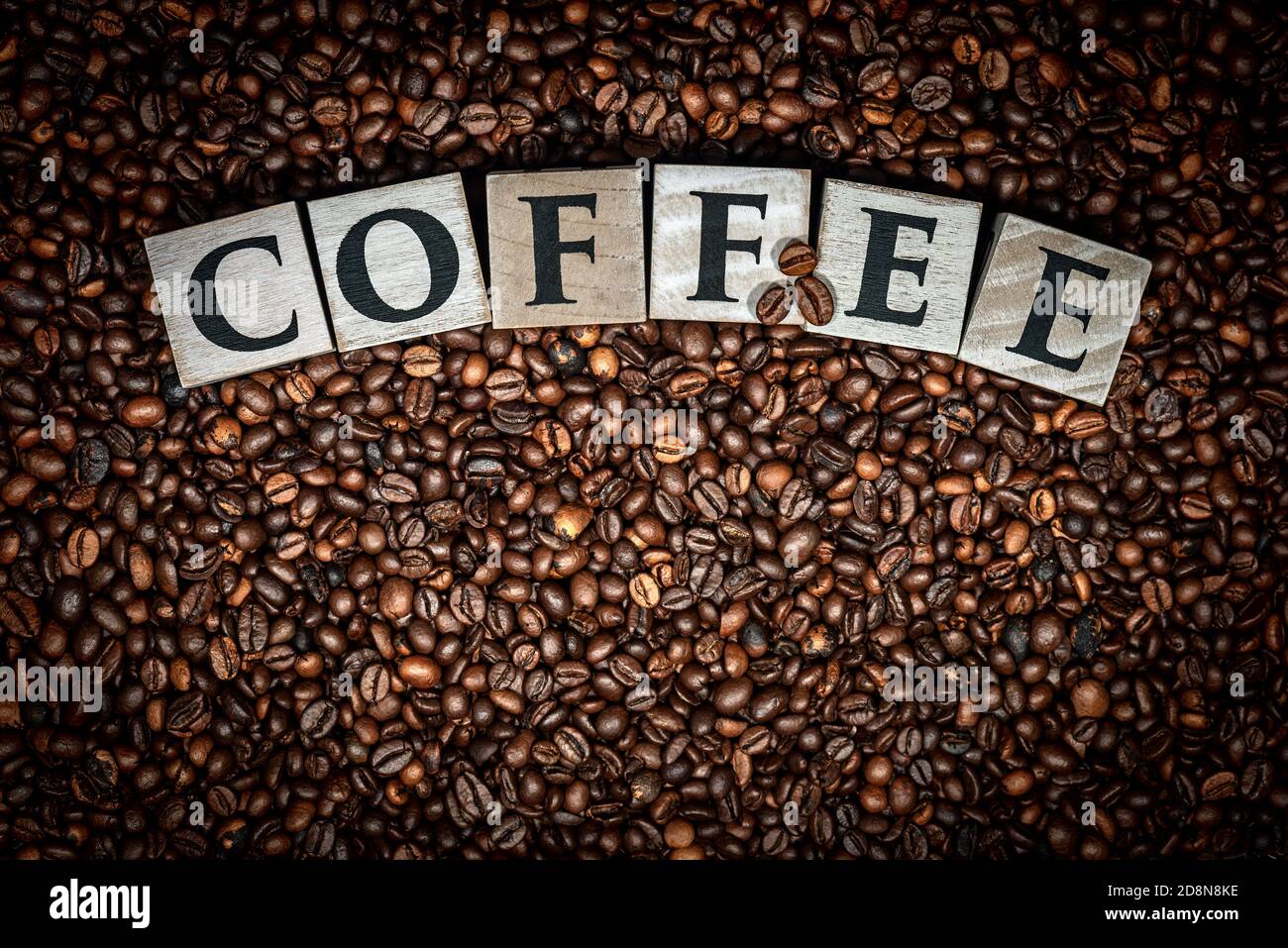 Single word Coffee, made of wooden blocks on Background with roasted ...