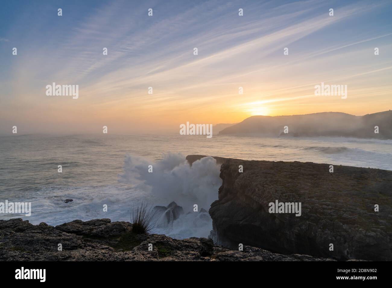A view of huge storm surge ocean waves crashing onto shore and cliffs ...