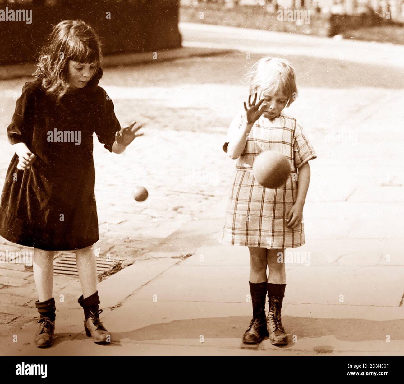 Children bouncing balls, early 1900s Stock Photo - Alamy