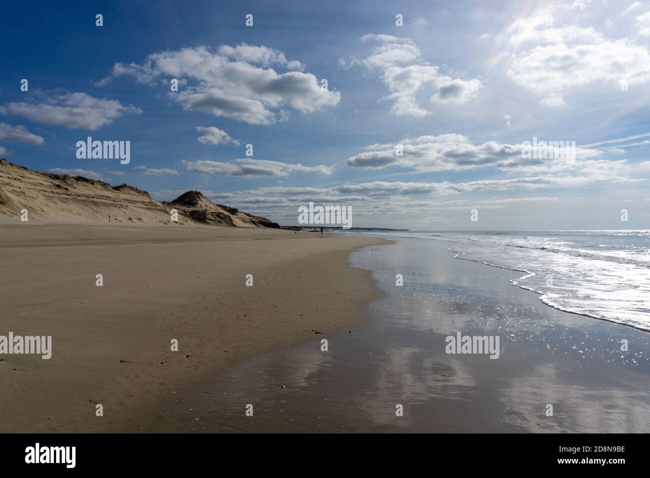 A wide empty beach and sand dunes on the Atlantic Ocean coast in France ...