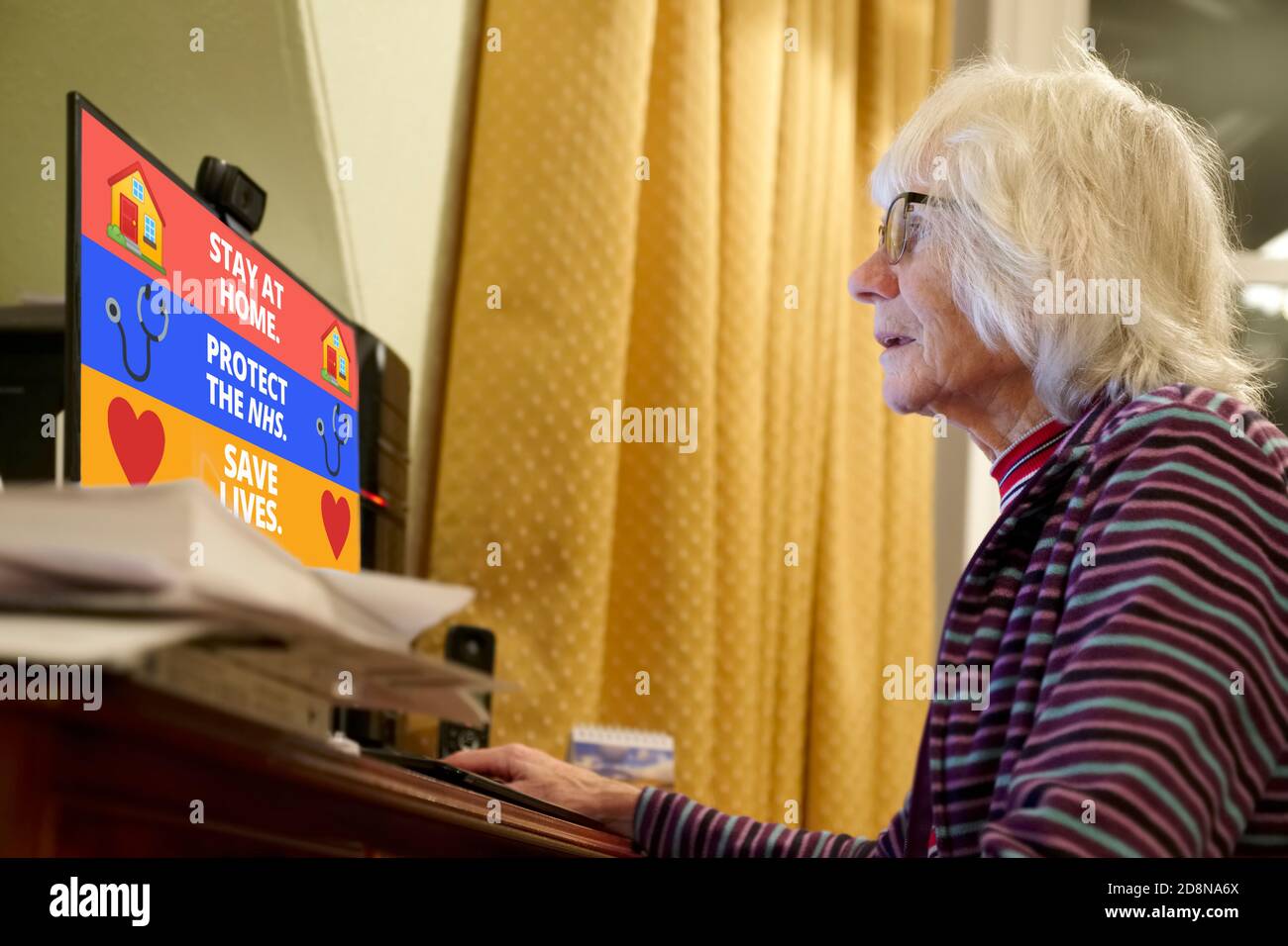 Senior old lady reading new coronavirus guidelines at computer monitor ...