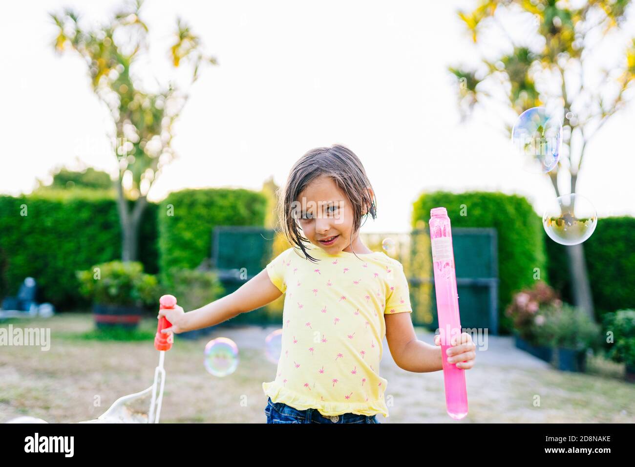 Girl playing with water bubbles Stock Photo - Alamy