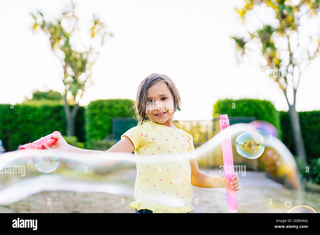 Girl playing with water bubbles Stock Photo - Alamy