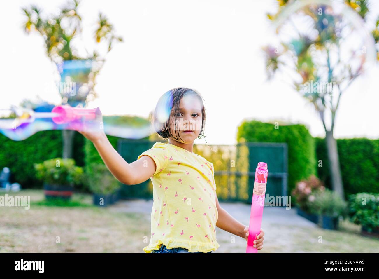 Girl playing with water bubbles Stock Photo - Alamy
