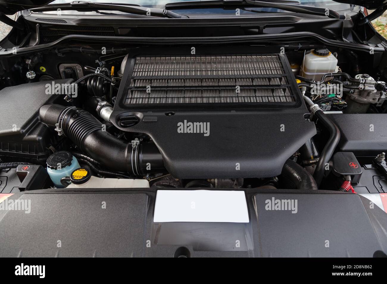 Front engine compartment of an old Japanese car with clean components ...