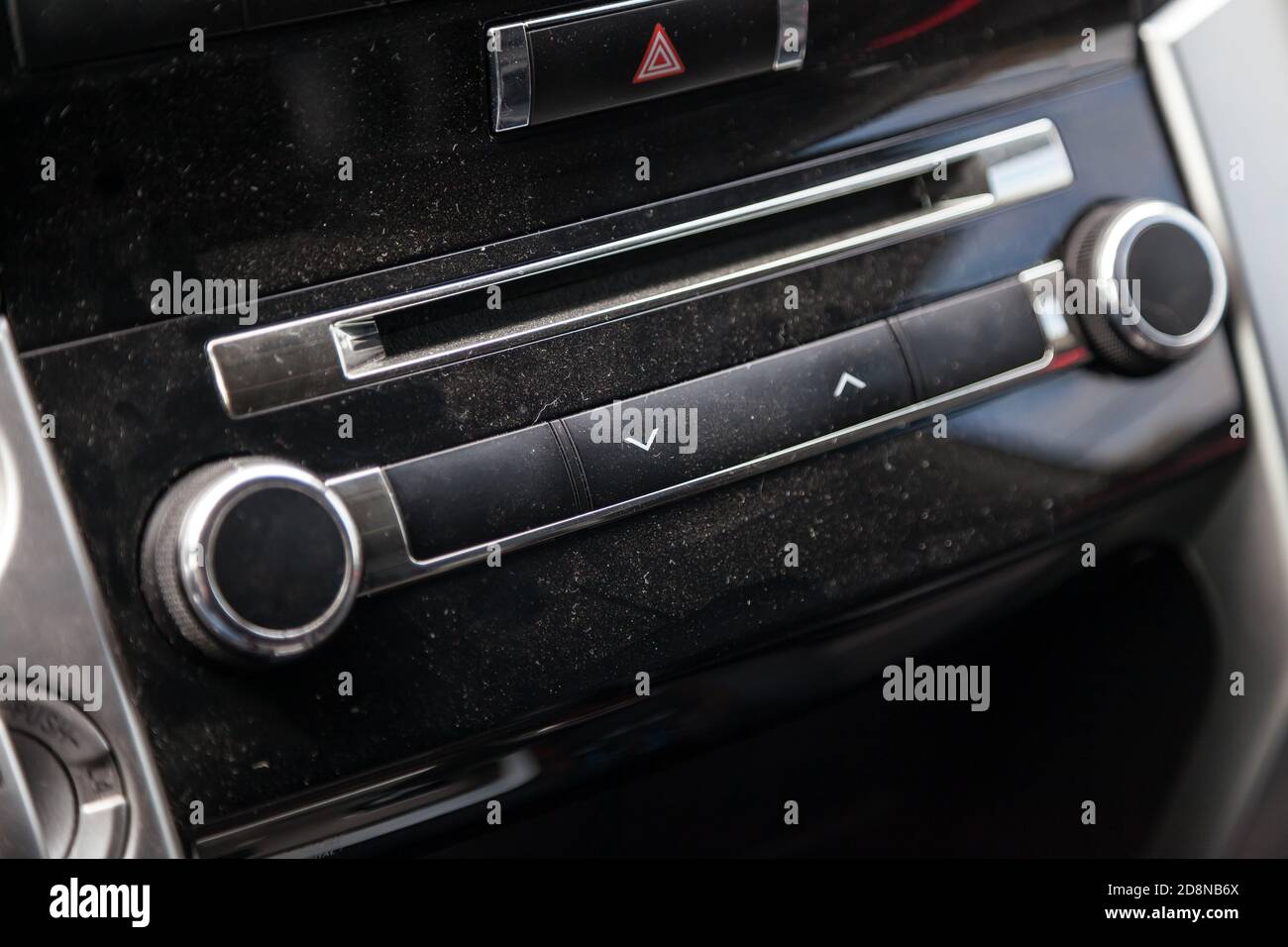 Close-up of a black plastic center console with a stereo music system ...