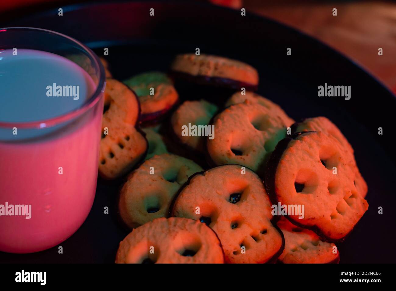 Halloween skill cookies with milk Stock Photo - Alamy