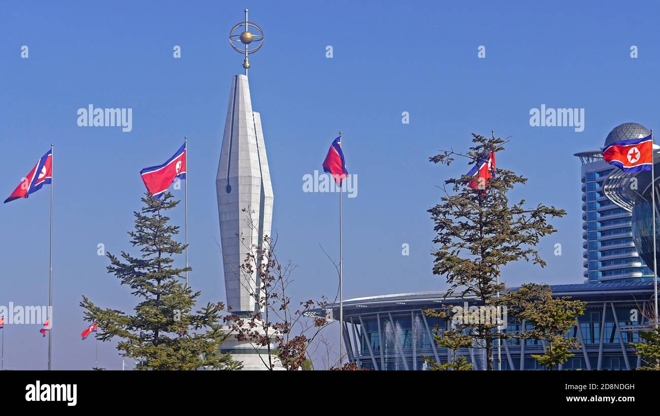 National flags and column monument landmark near stadium in Pyongyang ...