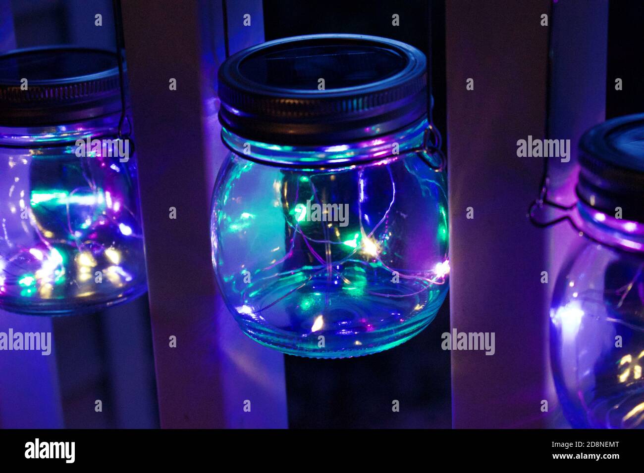 Hand holding mason Jar filled with neon LED lights inside Stock Photo ...