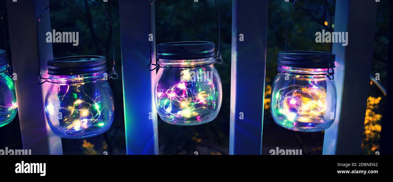 Hand holding mason Jar filled with neon LED lights inside Stock Photo ...
