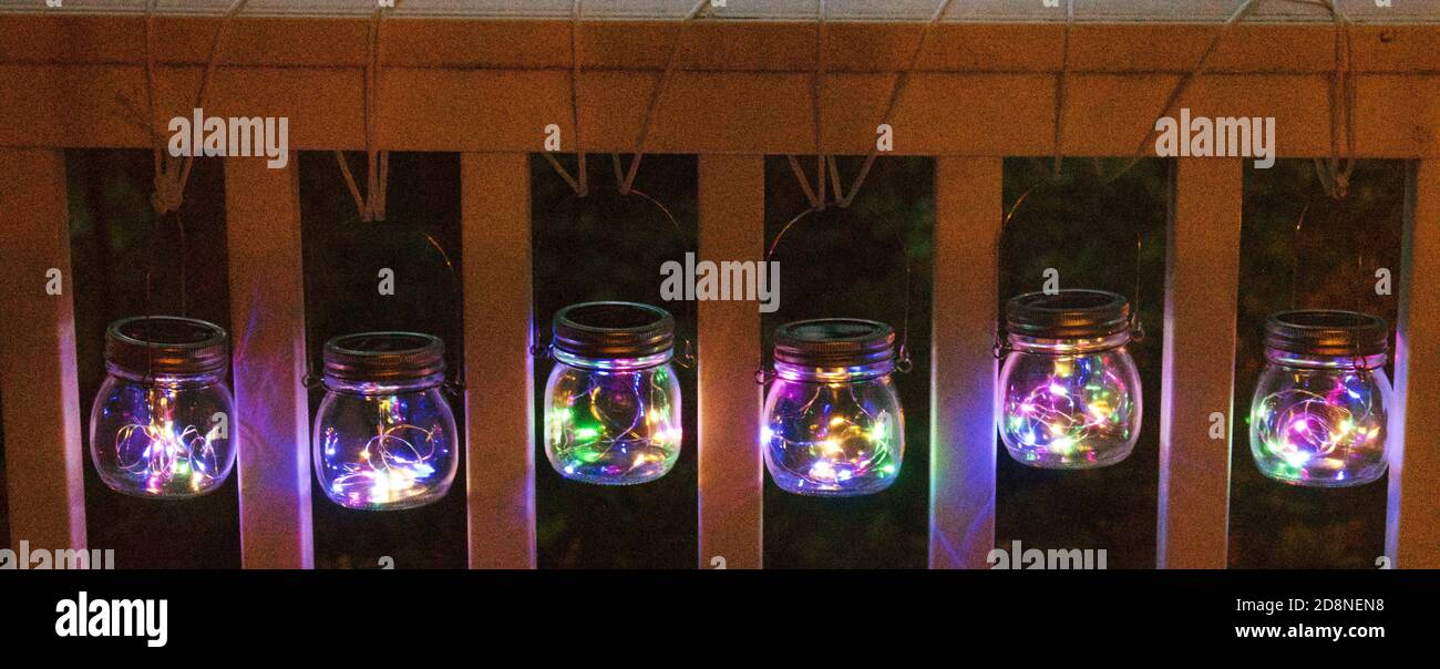 Hand holding mason Jar filled with neon LED lights inside Stock Photo ...