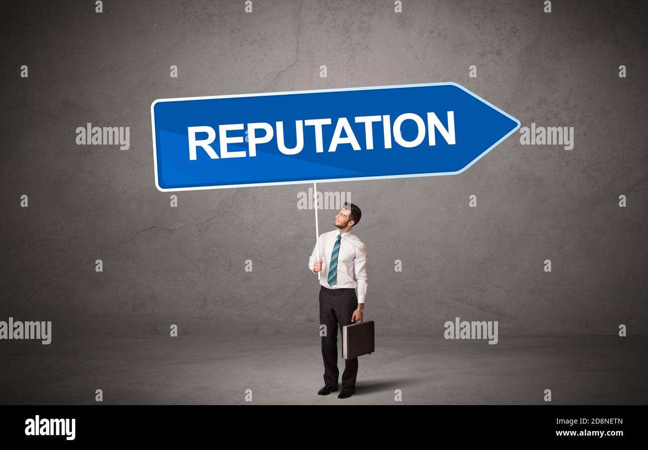 Young business person in casual holding road sign with REPUTATION ...