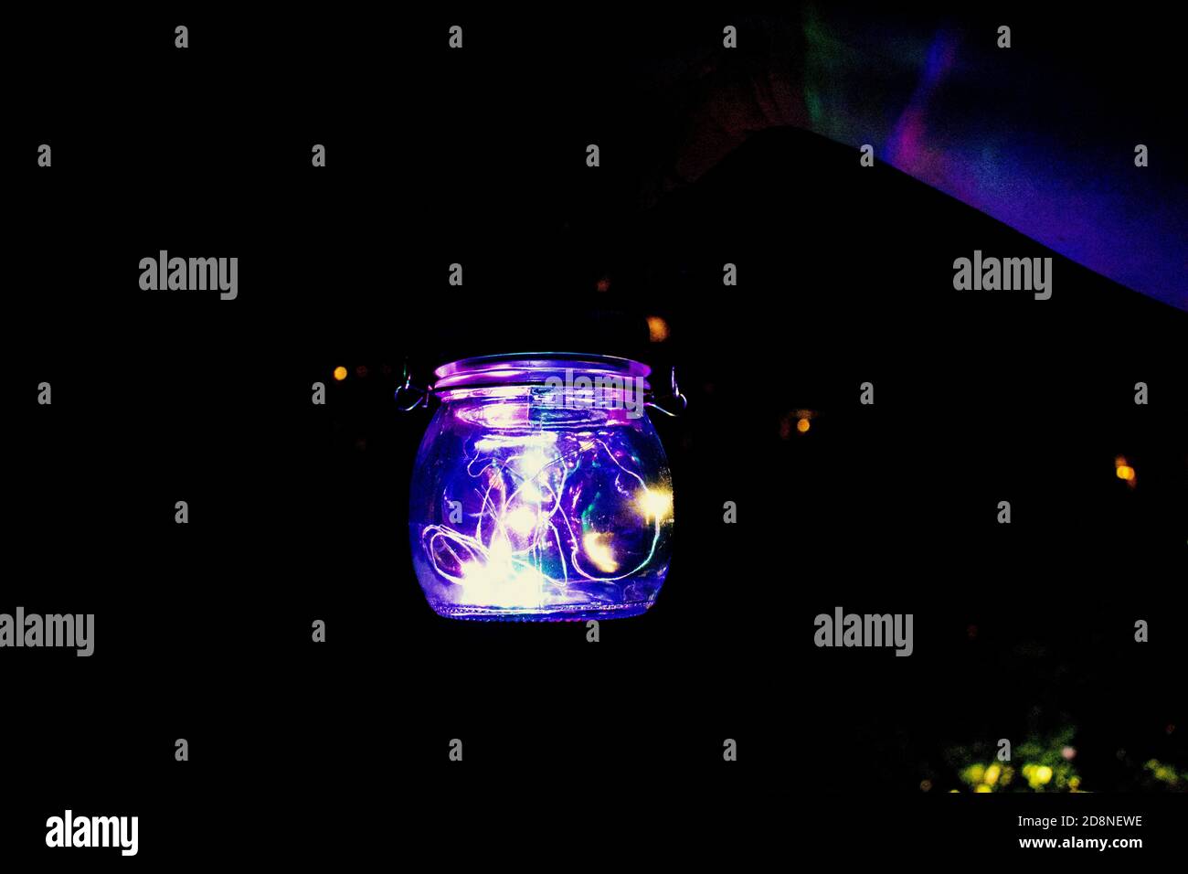 Hand holding mason Jar filled with neon LED lights inside Stock Photo ...