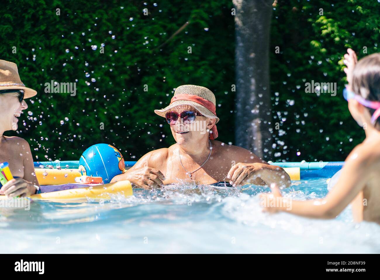 A family in the pool at home Stock Photo - Alamy