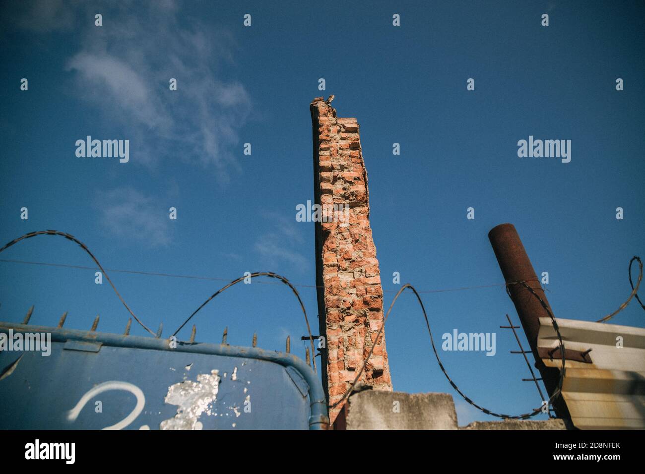 Low angle shot of a tall destroyed building with barbed wires Stock ...