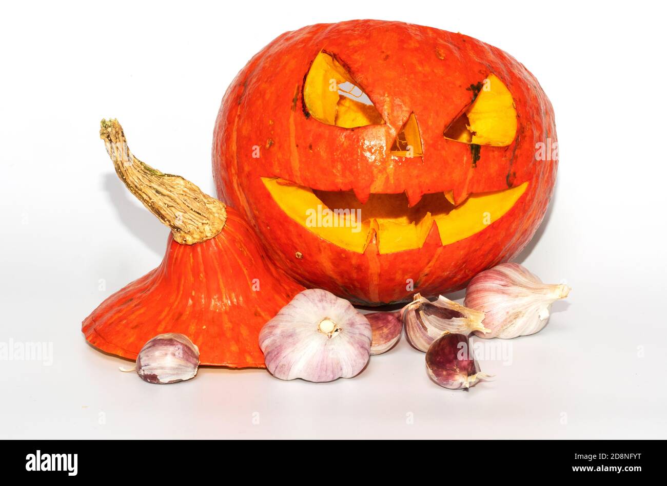 In this photo illustration a scary Halloween pumpkin with garlic on ...