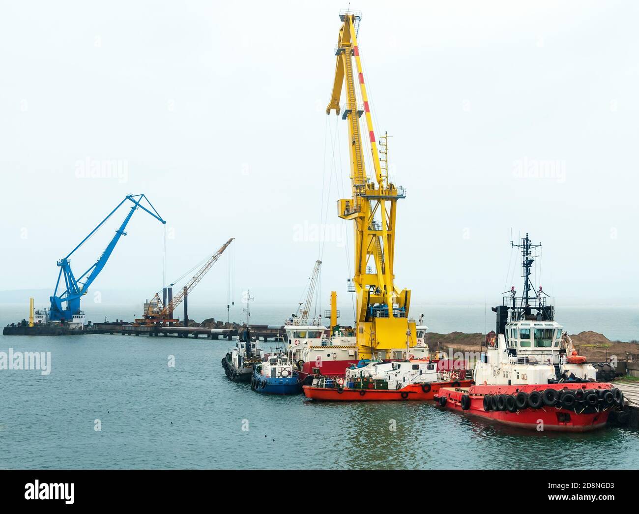 Floating cranes on the construction of the bridge Stock Photo - Alamy