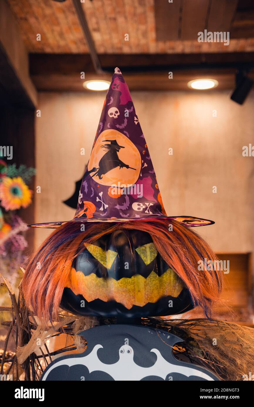 Decorative head Halloween scary pumpkin emotion face in a hat with the ...