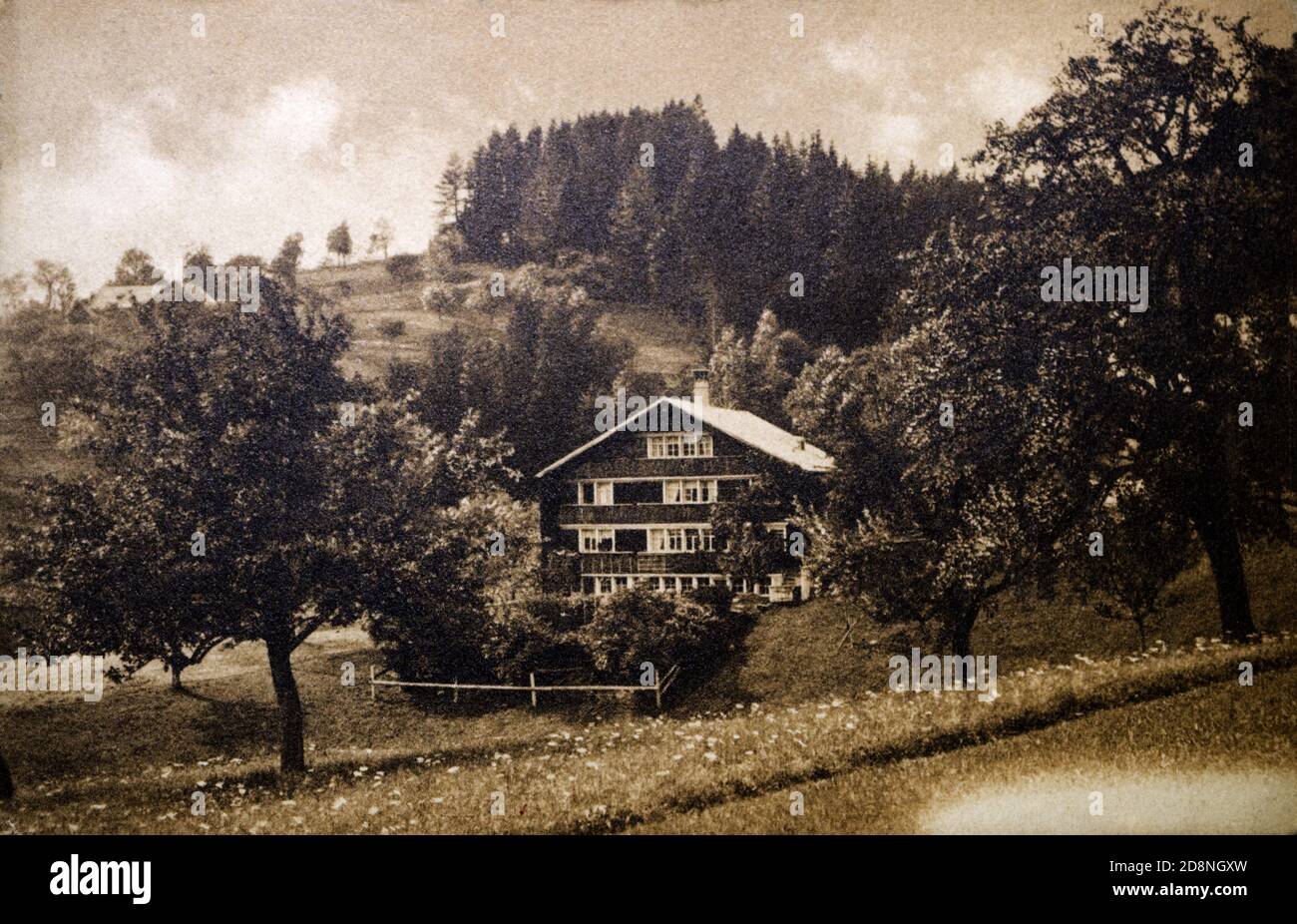 A historical view of a hotel in the Swiss countryside surrounded by ...