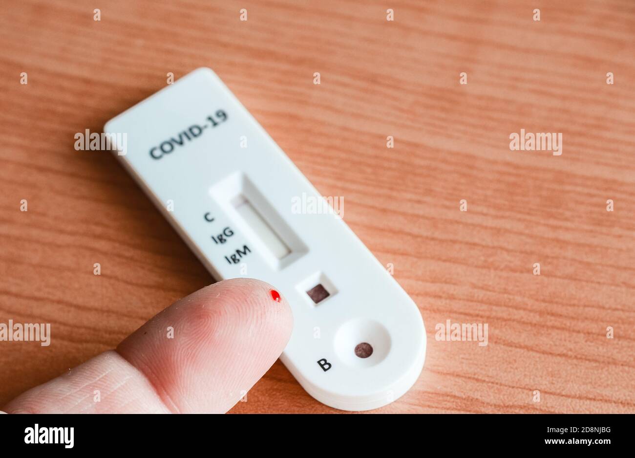 Close-up of finger with blood drop ready for covid-19 IgG/IgM rapid ...