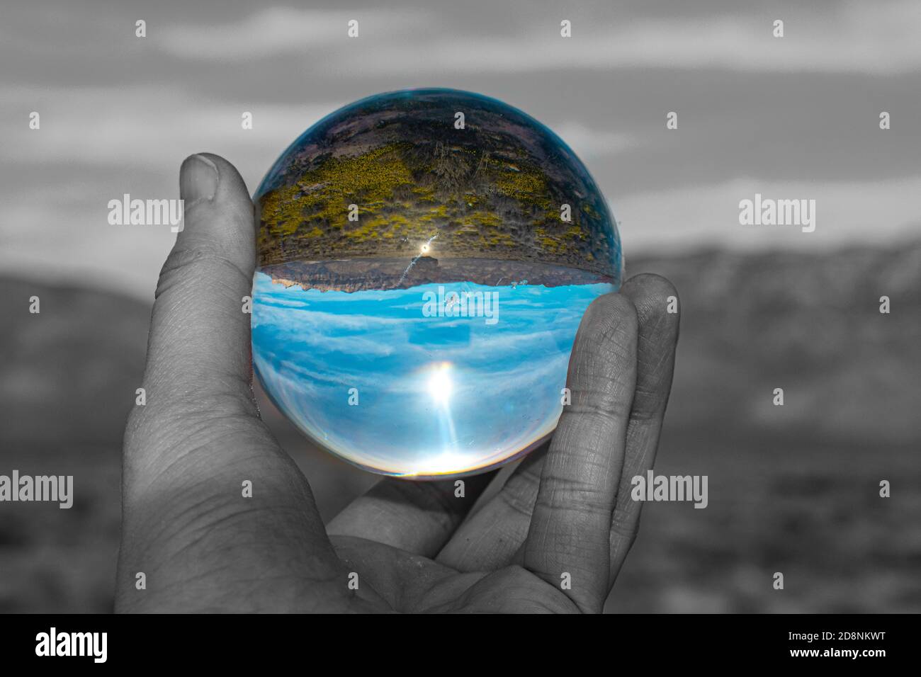 Reflection of desert landscape in glass ball, only the orb is in color ...