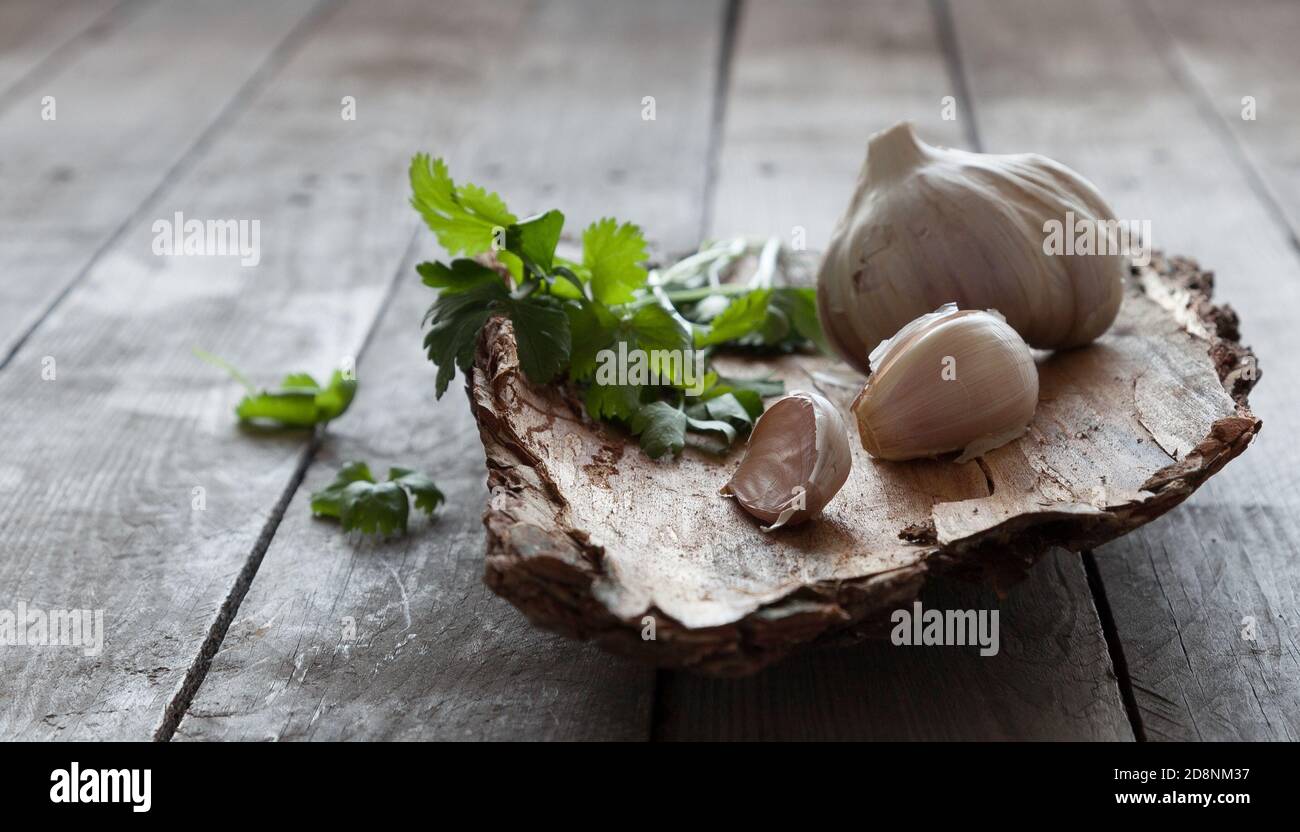garlic, coriander on raw wood background Stock Photo - Alamy