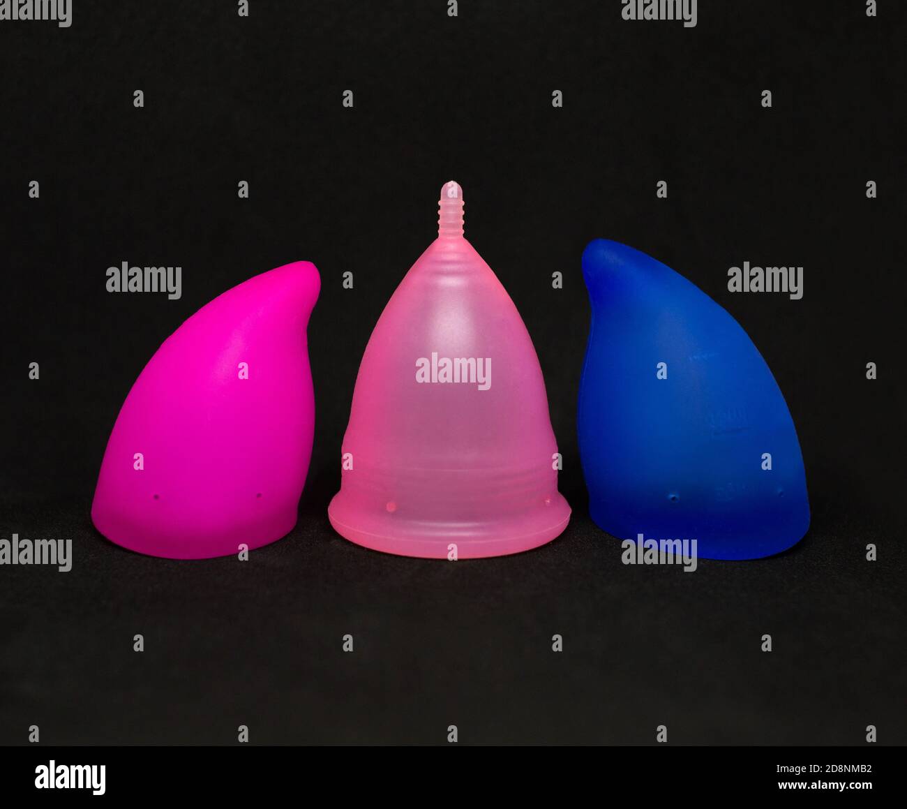 Three menstrual silicone cups different colors, shapes and capacity for ...