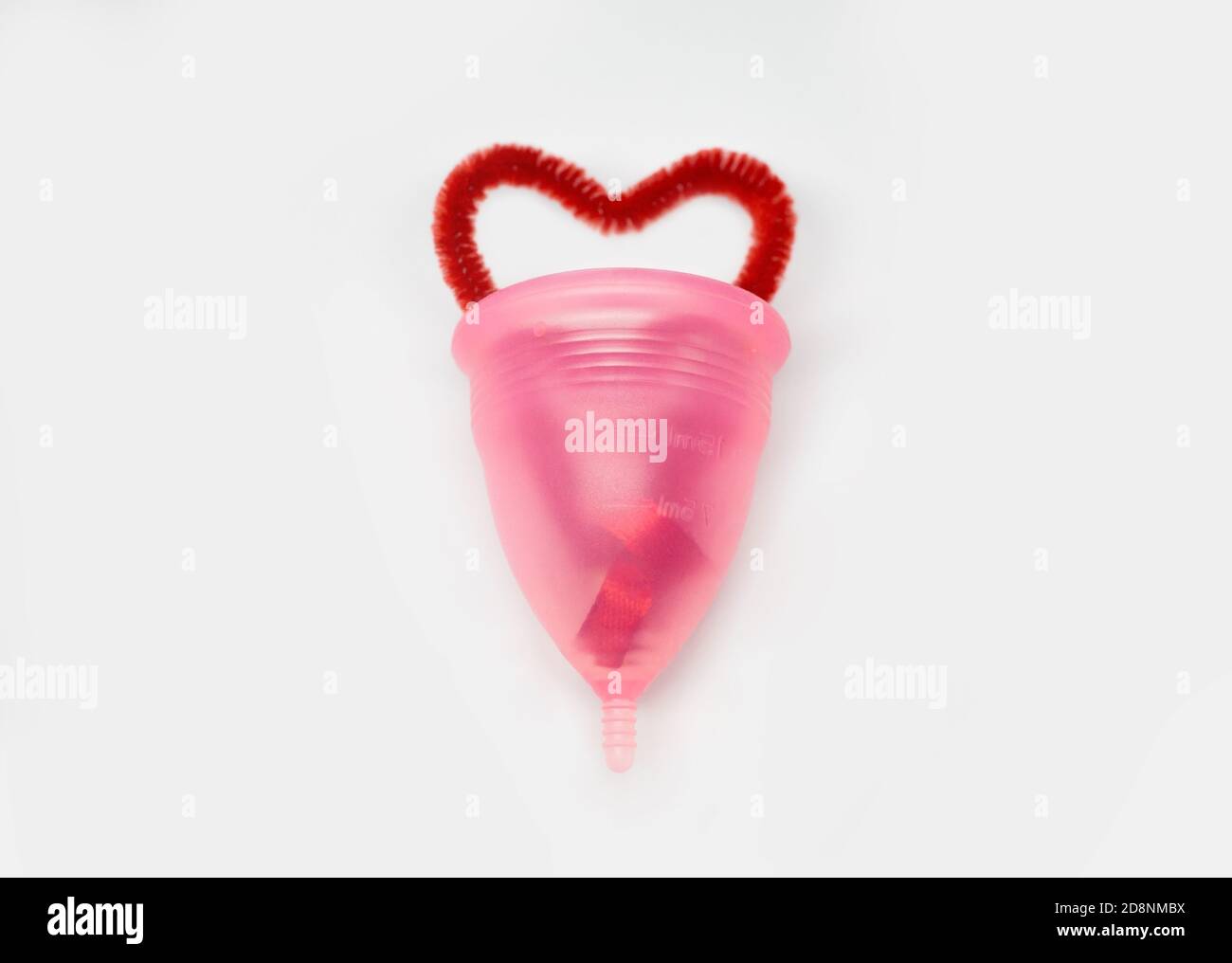 Pink menstrual cup from medical silicone with red heart shaped ...