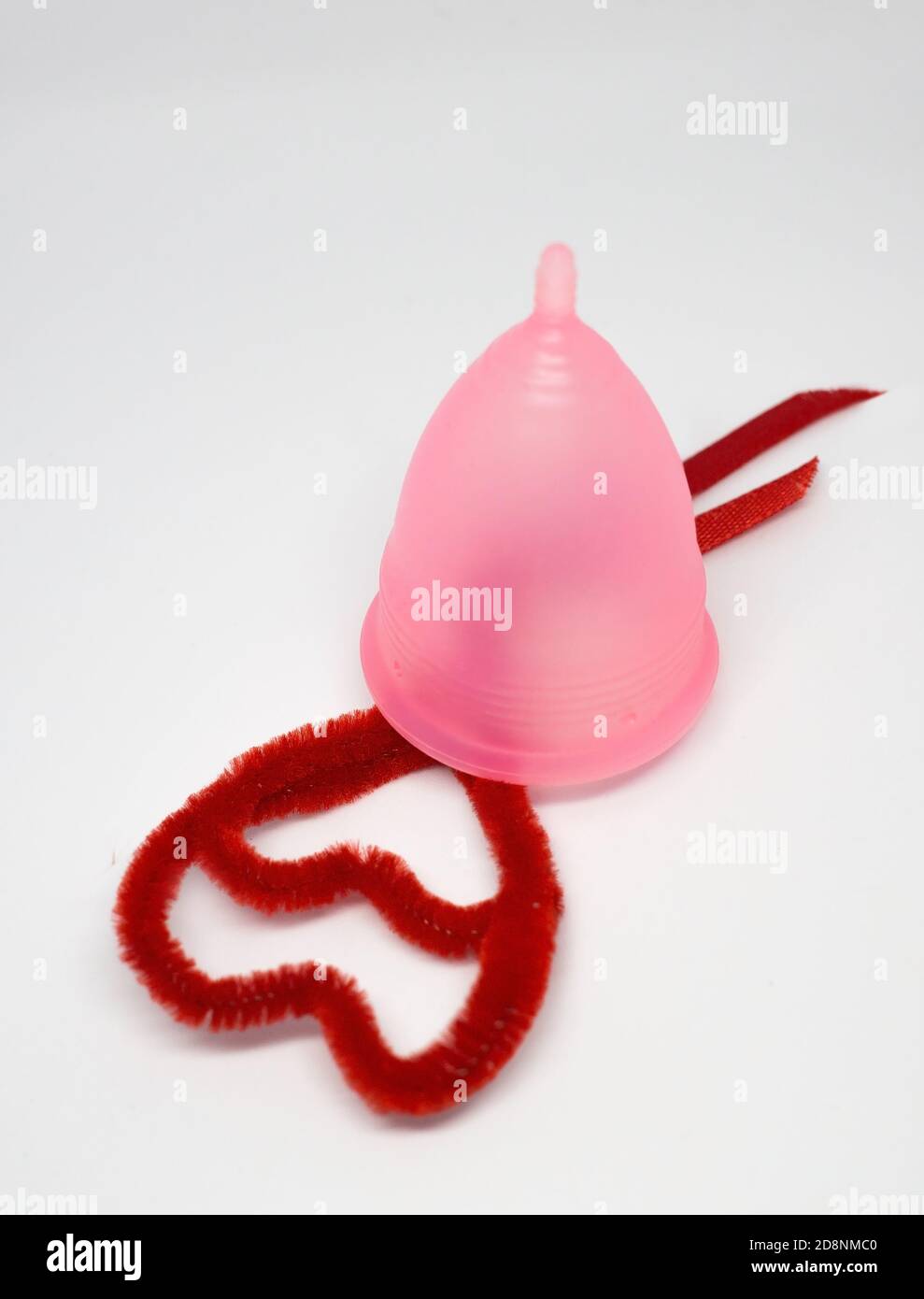 Pink menstrual cup from medical silicone with red heart shaped ...