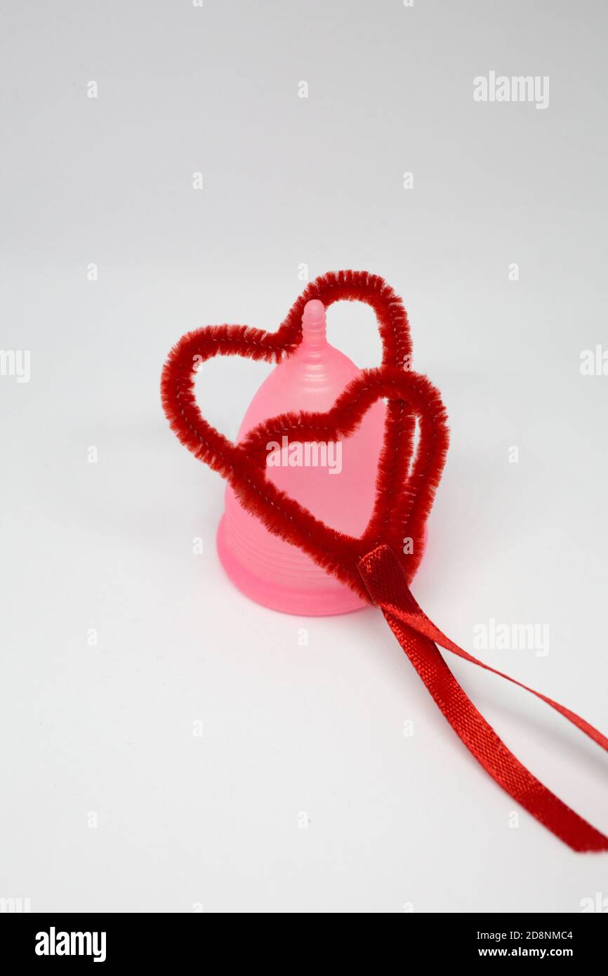 Pink menstrual cup from medical silicone with red heart shaped ...