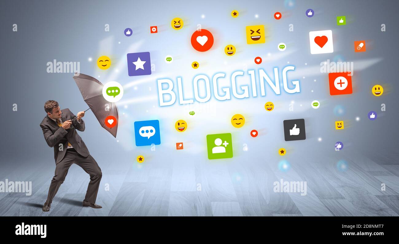 Handsome businessman defending with umbrella from BLOGGING inscription ...