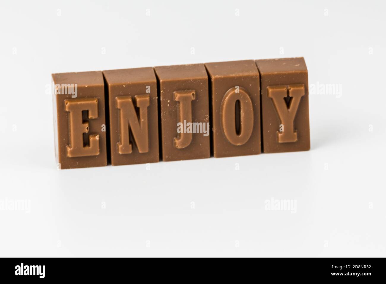 ENJOY lettering with chocolate bars on a white background Stock Photo ...