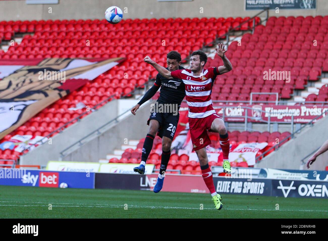 Joe Wright (5) of Doncaster Rovers and Brennan Johnson (20) of Lincoln ...