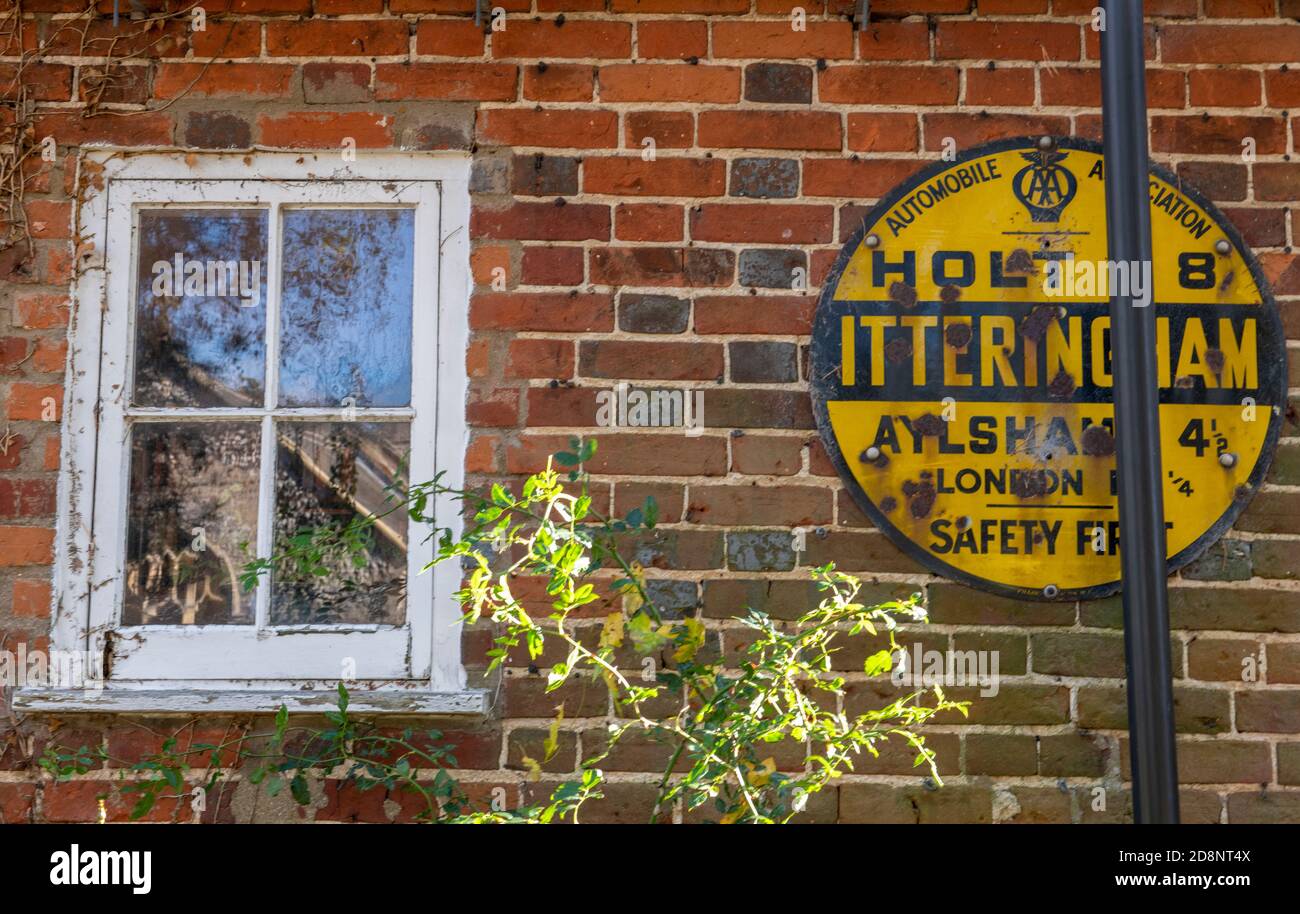 vintage enamel signs on the wall of an old historic red brick building ...