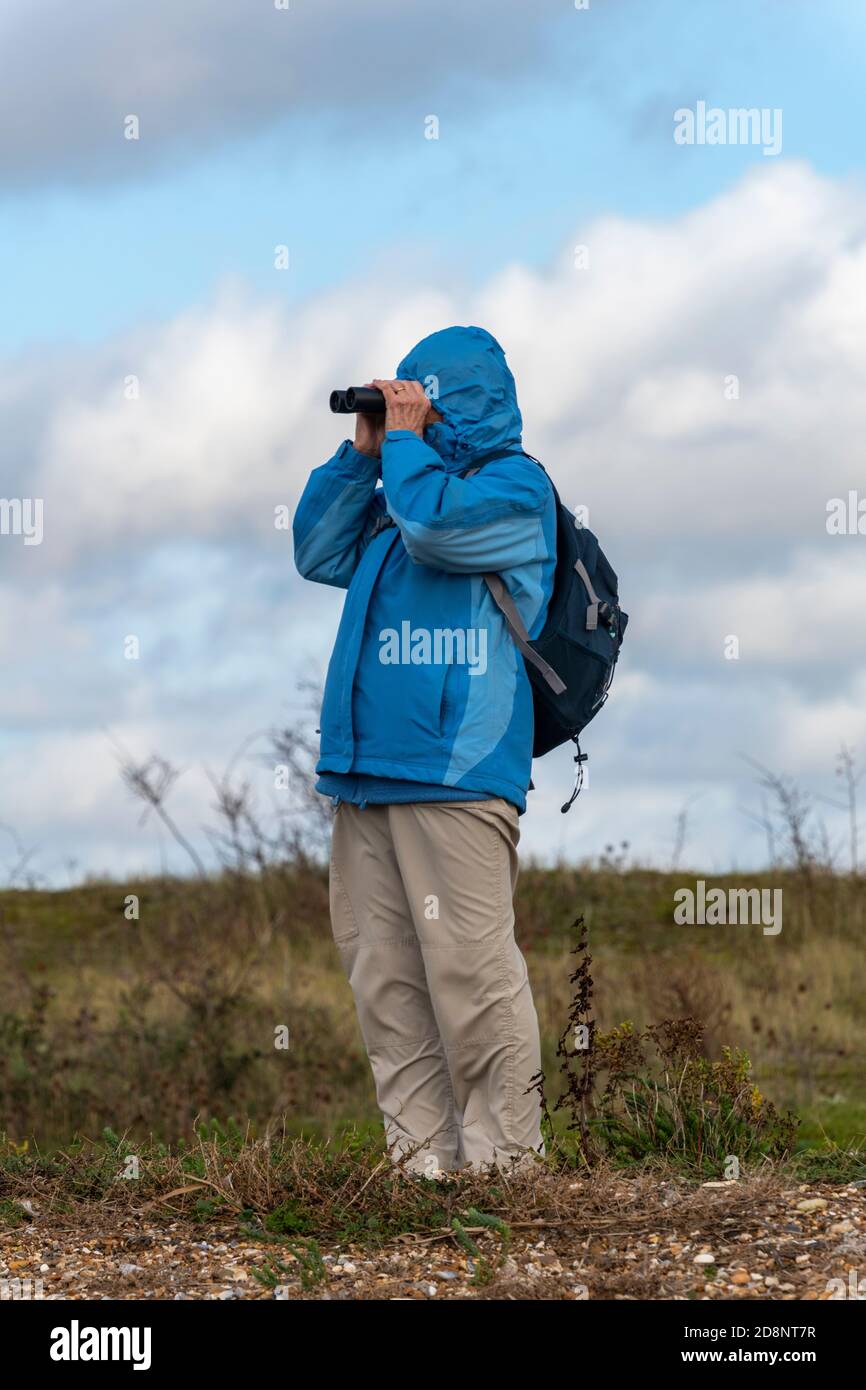 Birdwatcher birder twitcher looking through binoculars at the RSPB ...