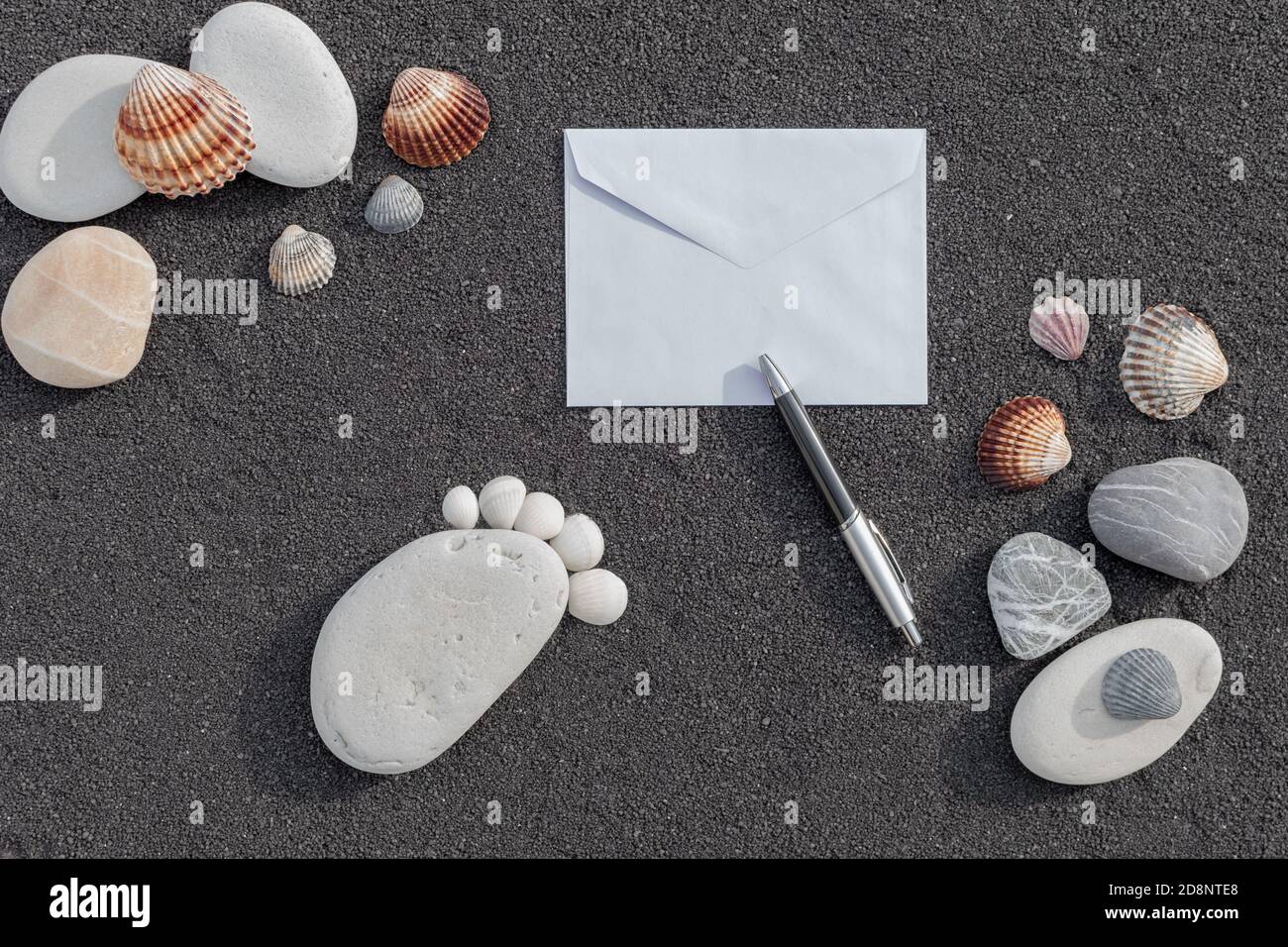 Background grains of sea sand, fine black beach sand with envelope and ...