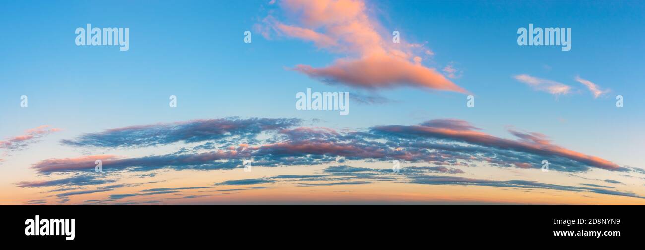 Vanilla sunset sky panoramic shot. Pink golden blue evening sky with ...