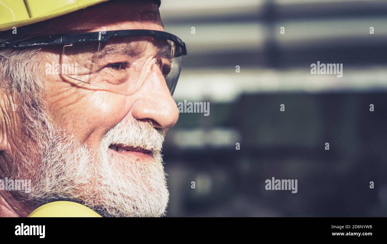 Senior factory worker or engineer close up portrait in factory ...
