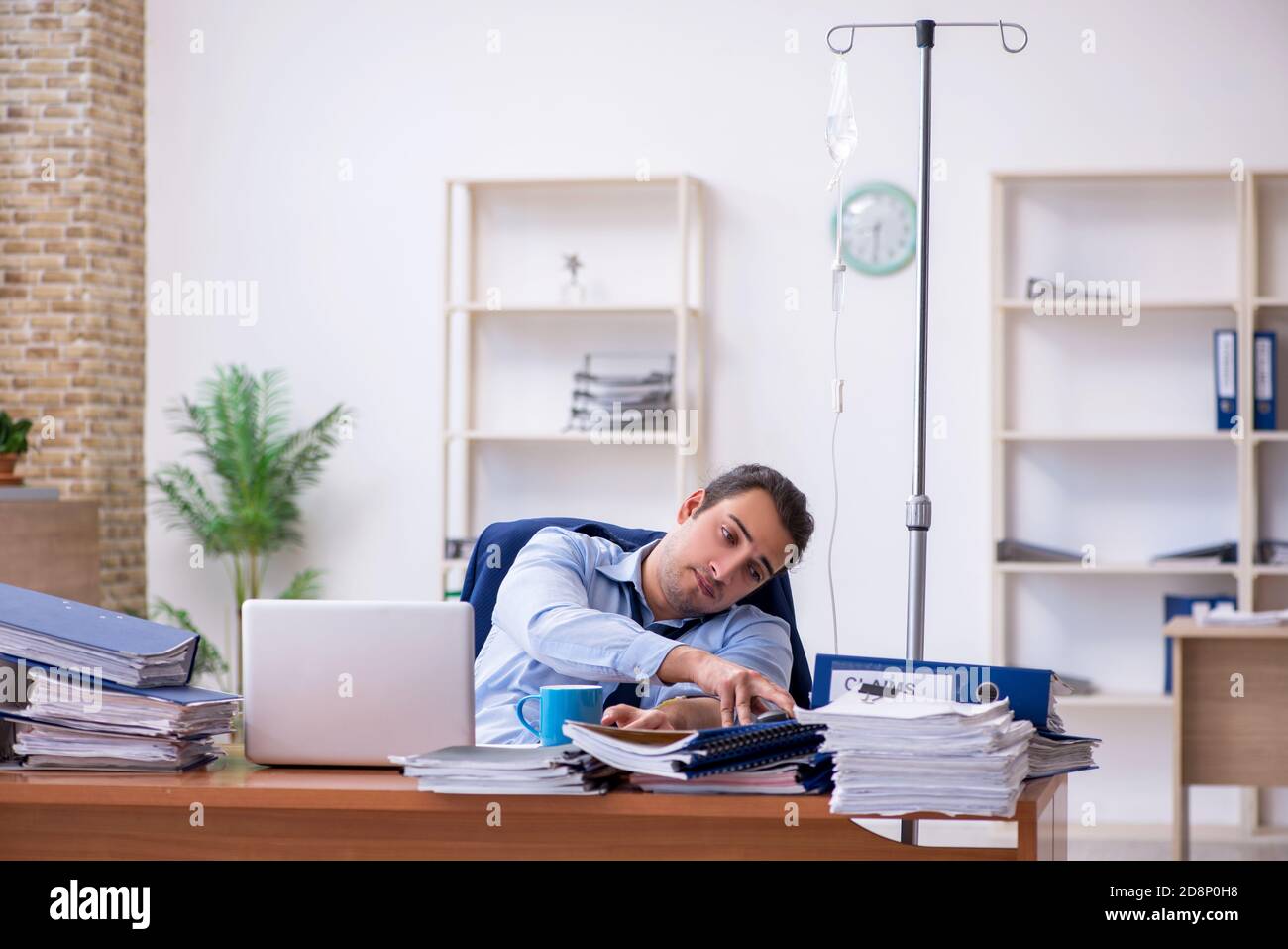 Male employee suffering at workplace Stock Photo - Alamy