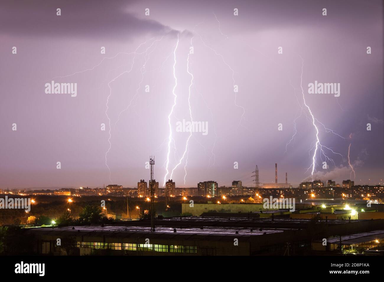 Powerful lightning strike hits the city at night. A strong lightning ...