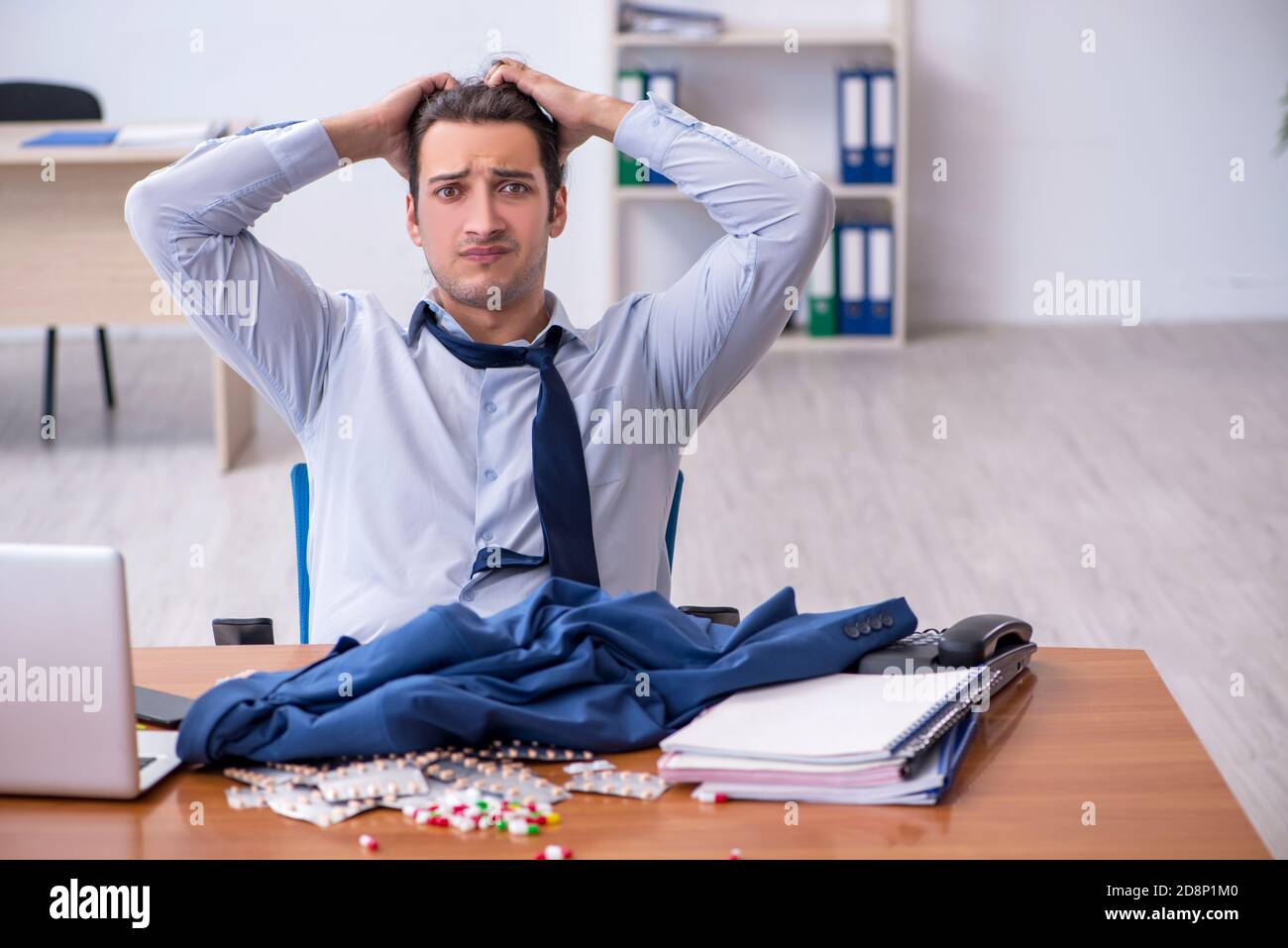 Sick male employee suffering at workplace Stock Photo - Alamy