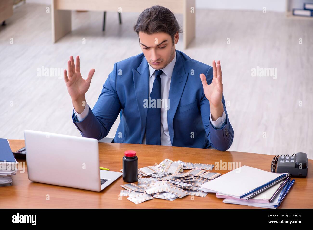 Sick male employee suffering at workplace Stock Photo - Alamy