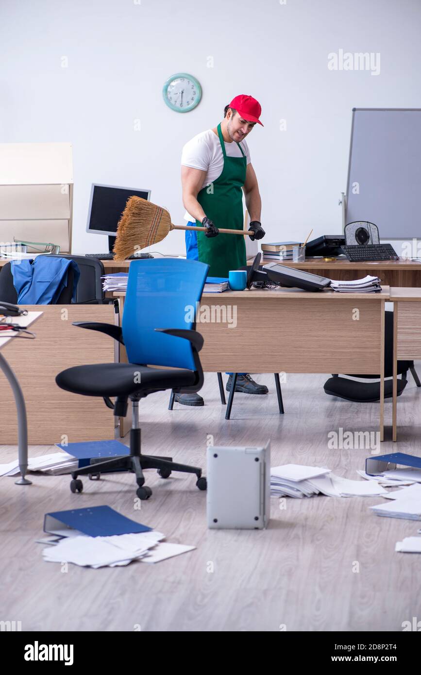 Young contractor cleaning the office Stock Photo - Alamy