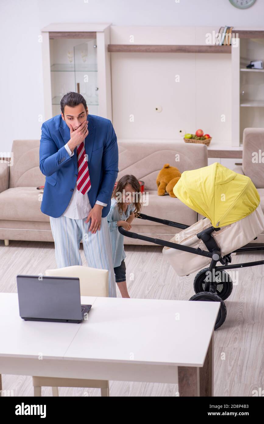 Young father of two children working from house Stock Photo - Alamy